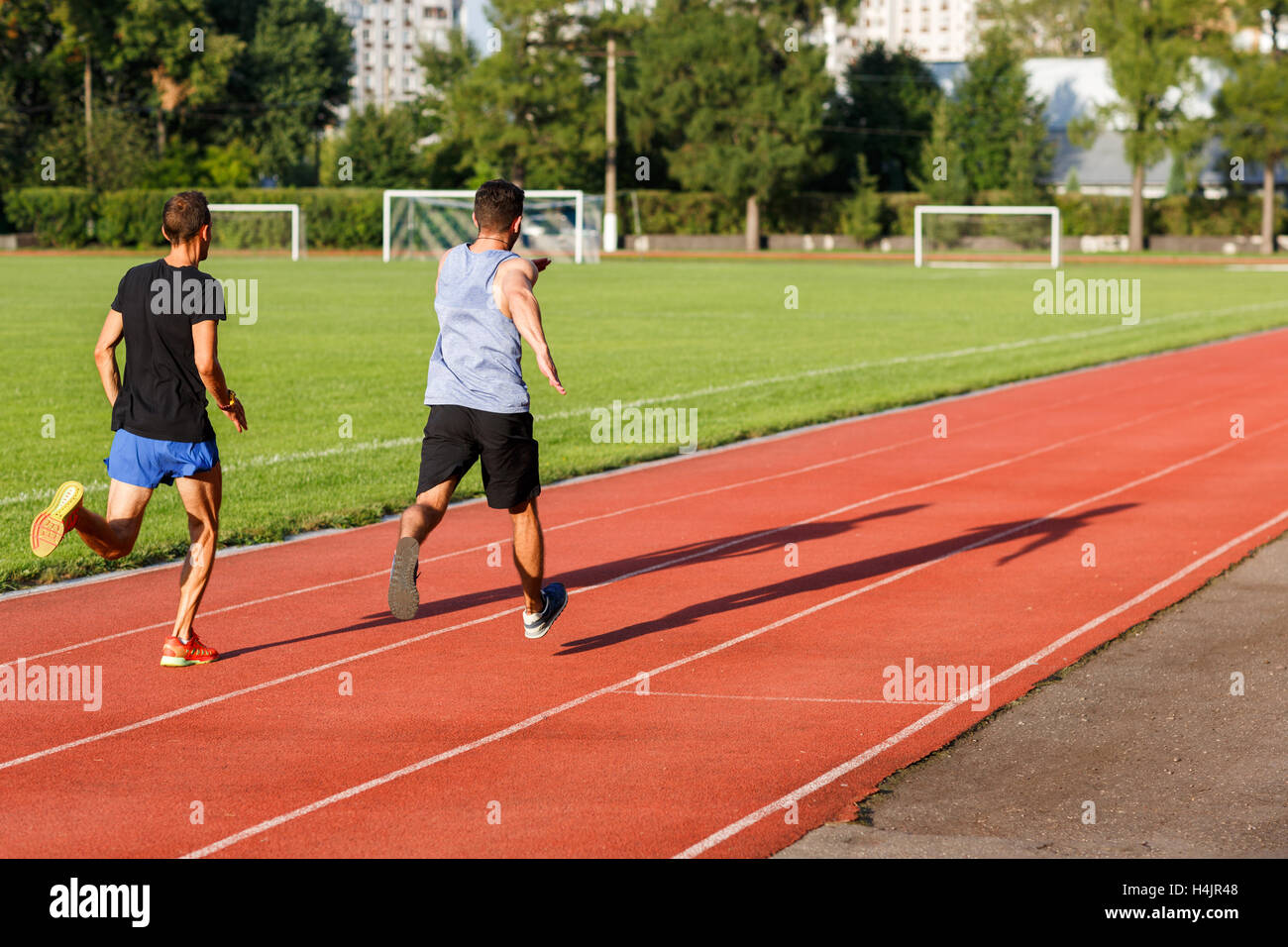 Two athletic men compete who runs faster Stock Photo - Alamy
