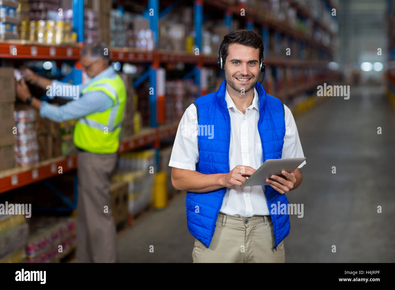 Warehouse worker holding digital tablet Stock Photo - Alamy