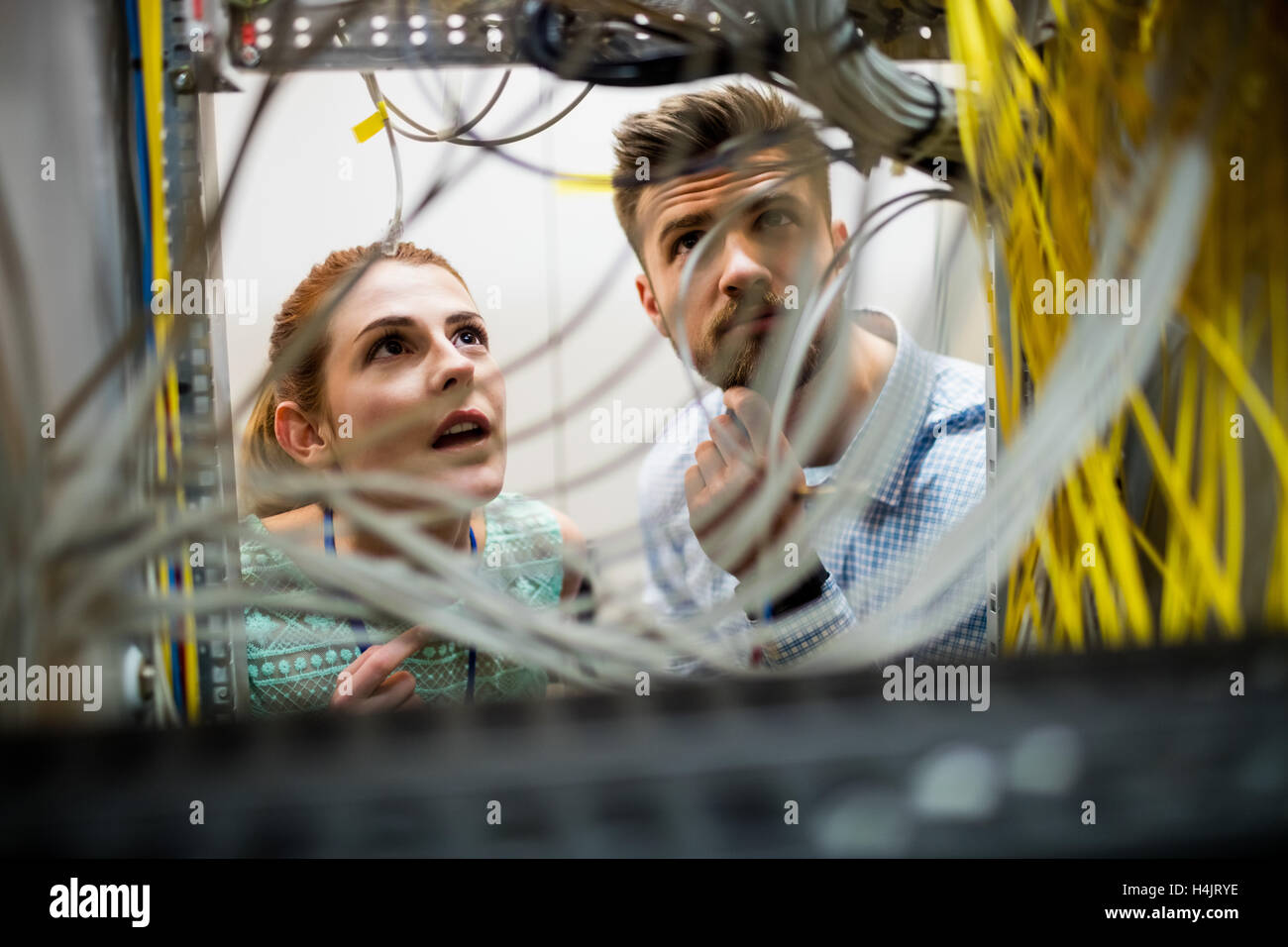 Technicians fixing cable Stock Photo - Alamy