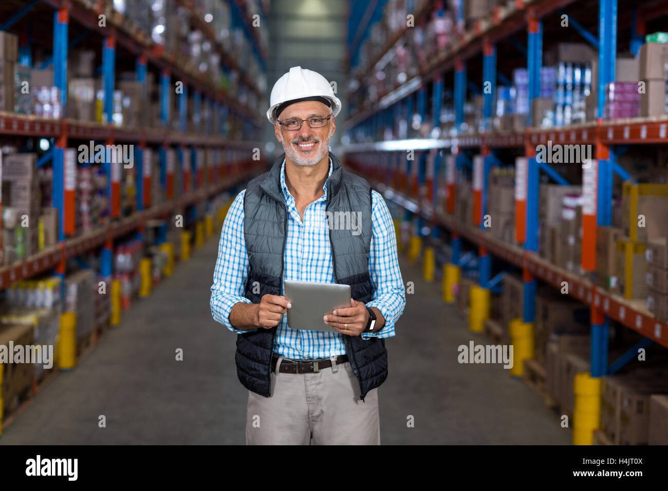 Portrait of warehouse worker using digital tablet Stock Photo - Alamy