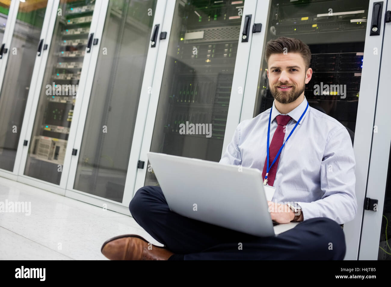 Technician using laptop Stock Photo - Alamy