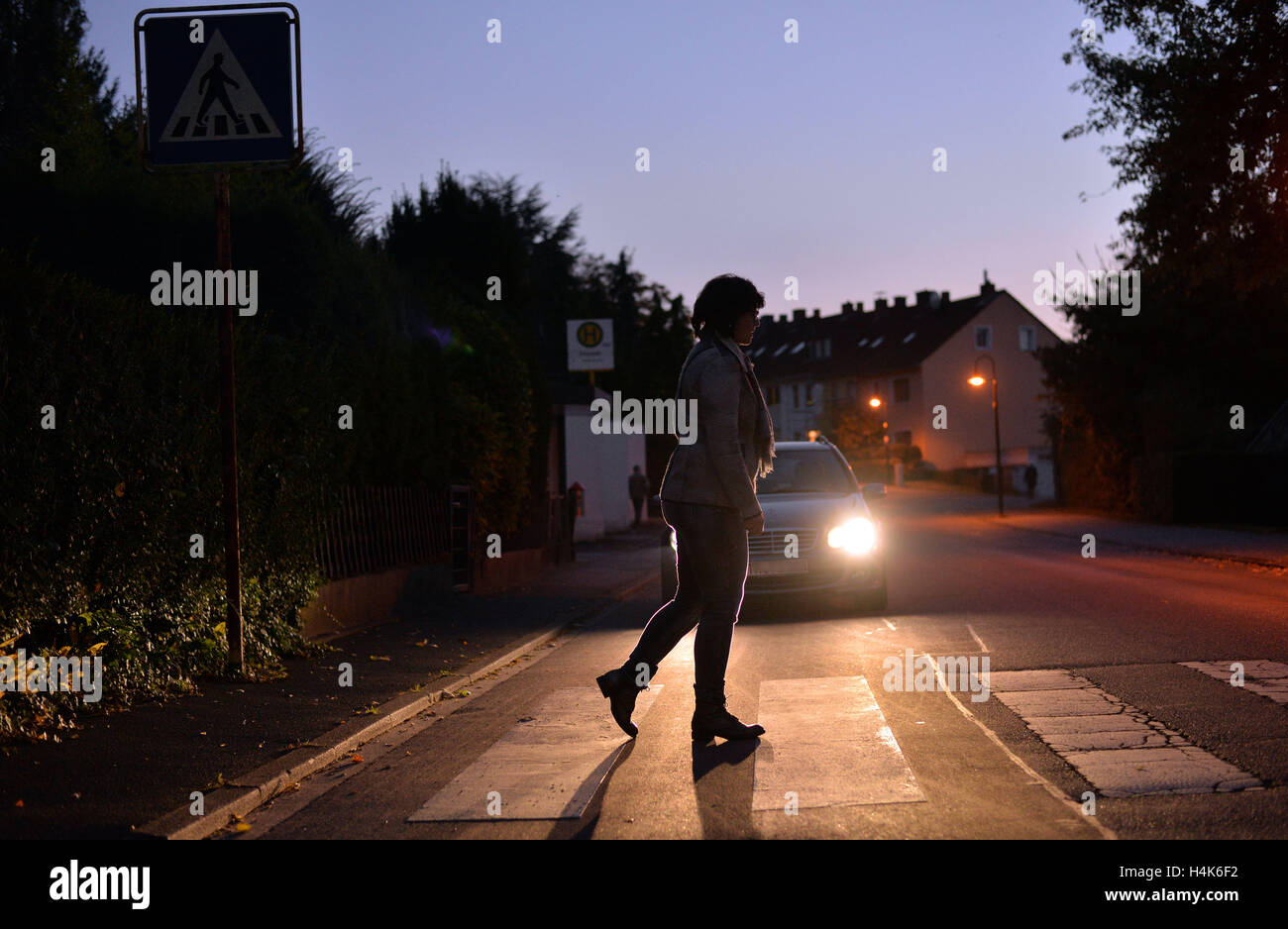 ILLUSTRATION - A woman walks across an unilluminated zebra crossing on ...