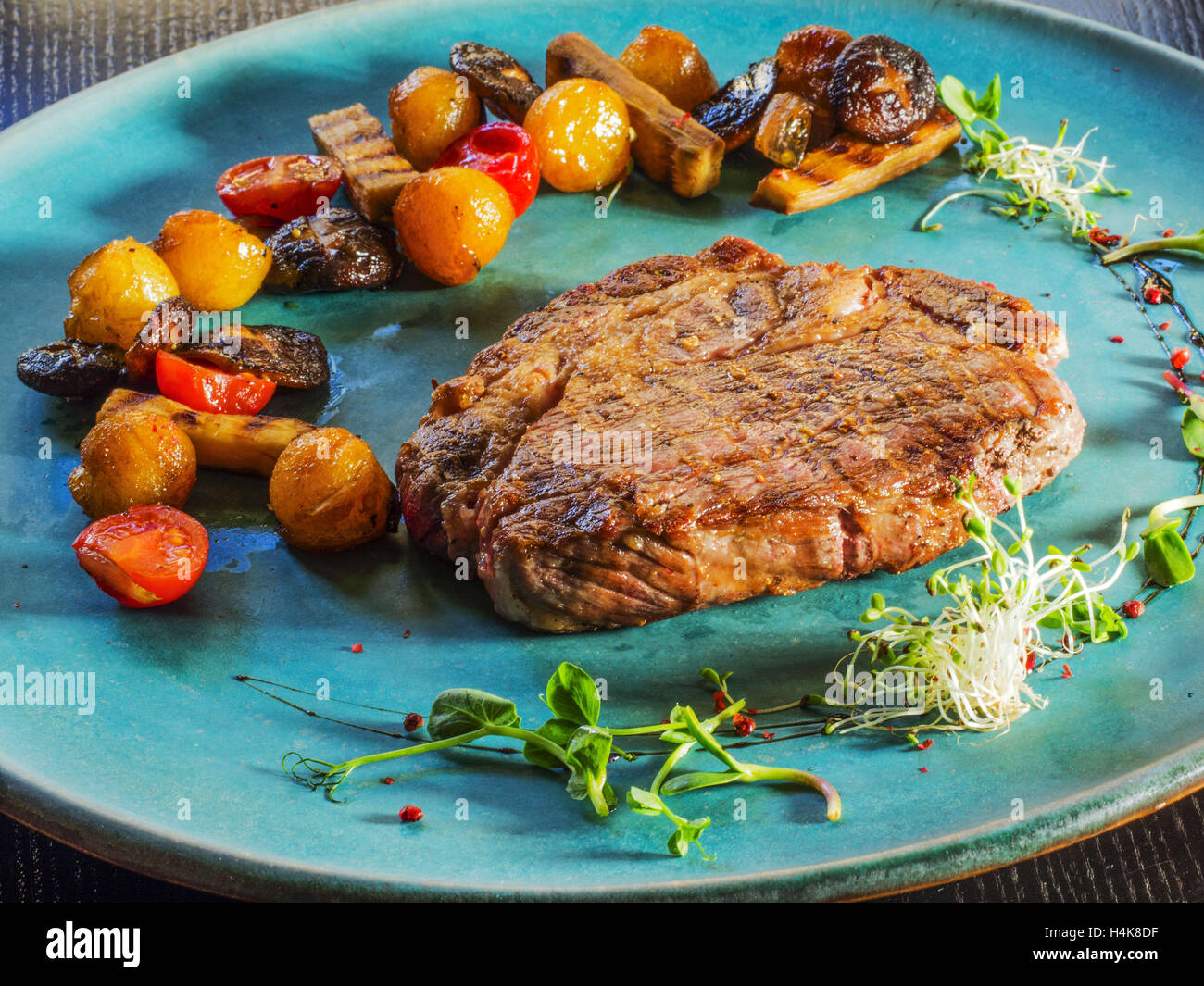 Grilled steaks and vegetables on blue plate. 6th Oct, 2016. © Igor ...