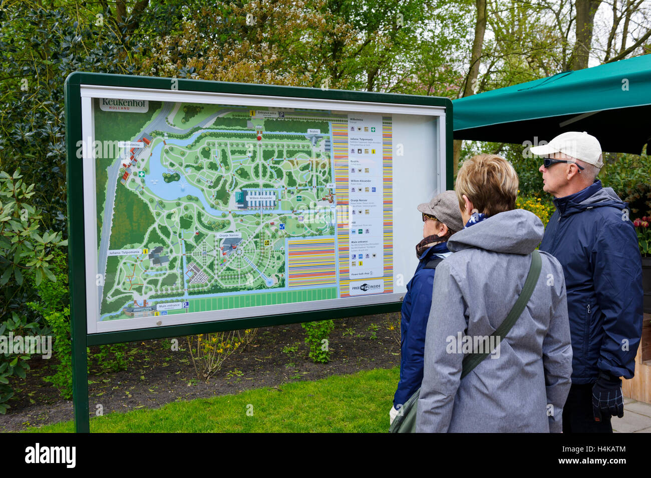 Visitors looking at a detailed map of Keukenhof garden in Lisse ...