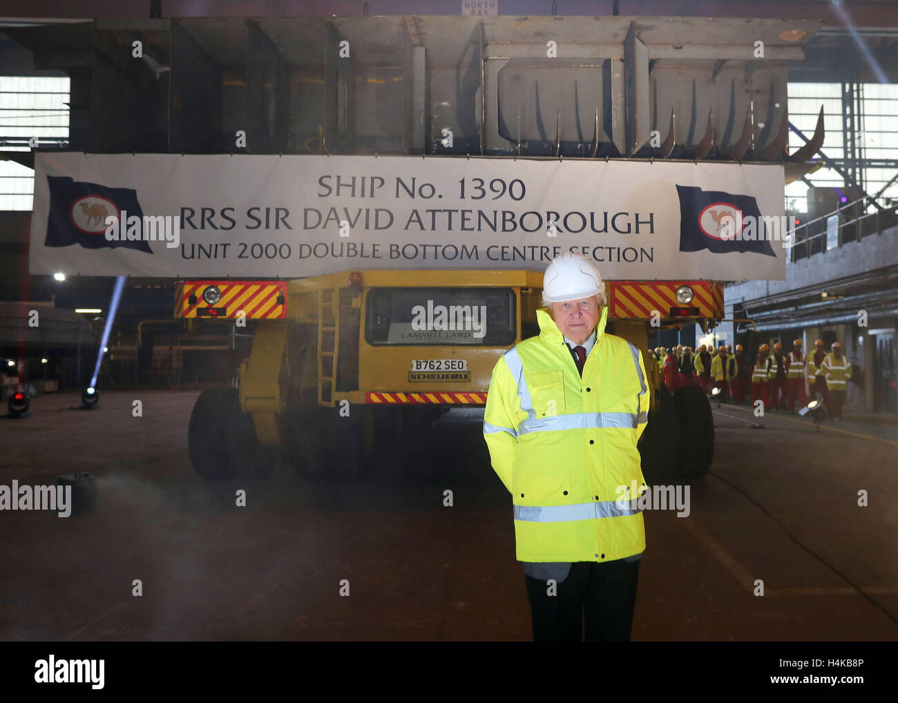 Sir David Attenborough stands in front of a section of the keel of the ...