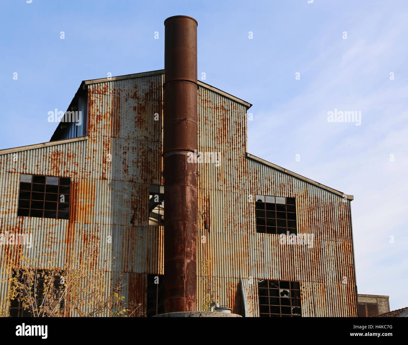 very old abbandoned rusty factory with high chimney Stock Photo - Alamy