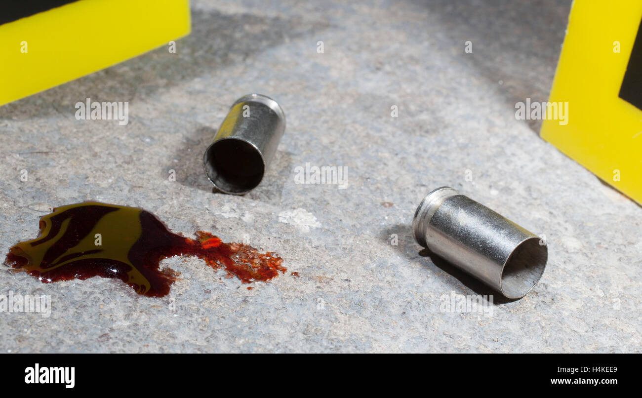 Crime scene with handgun casings, evidence markers and blood on ...