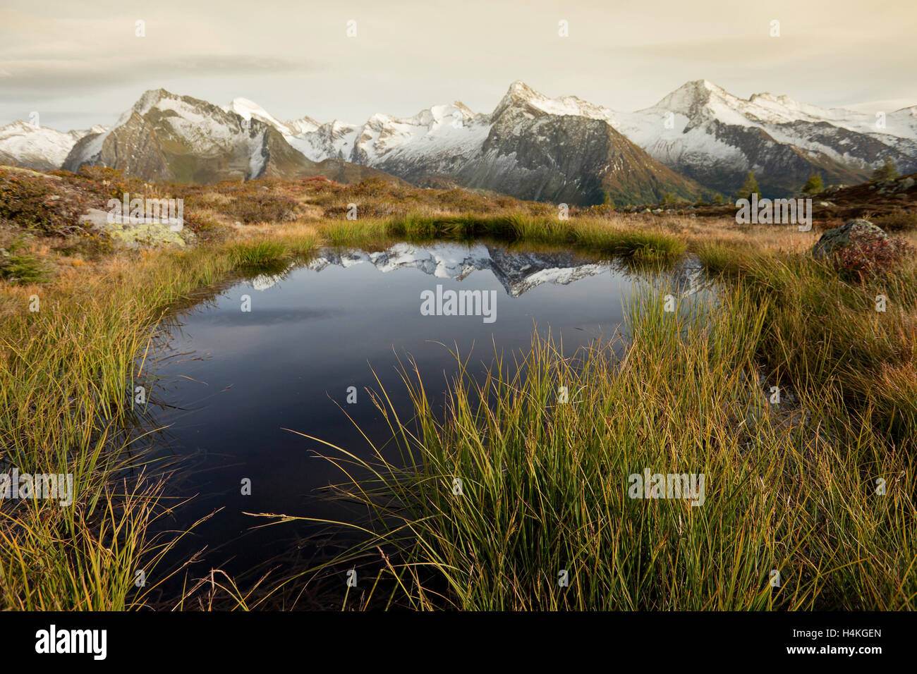 Alpine reflection: a small alpine lake in the Italian Alps; it's late ...
