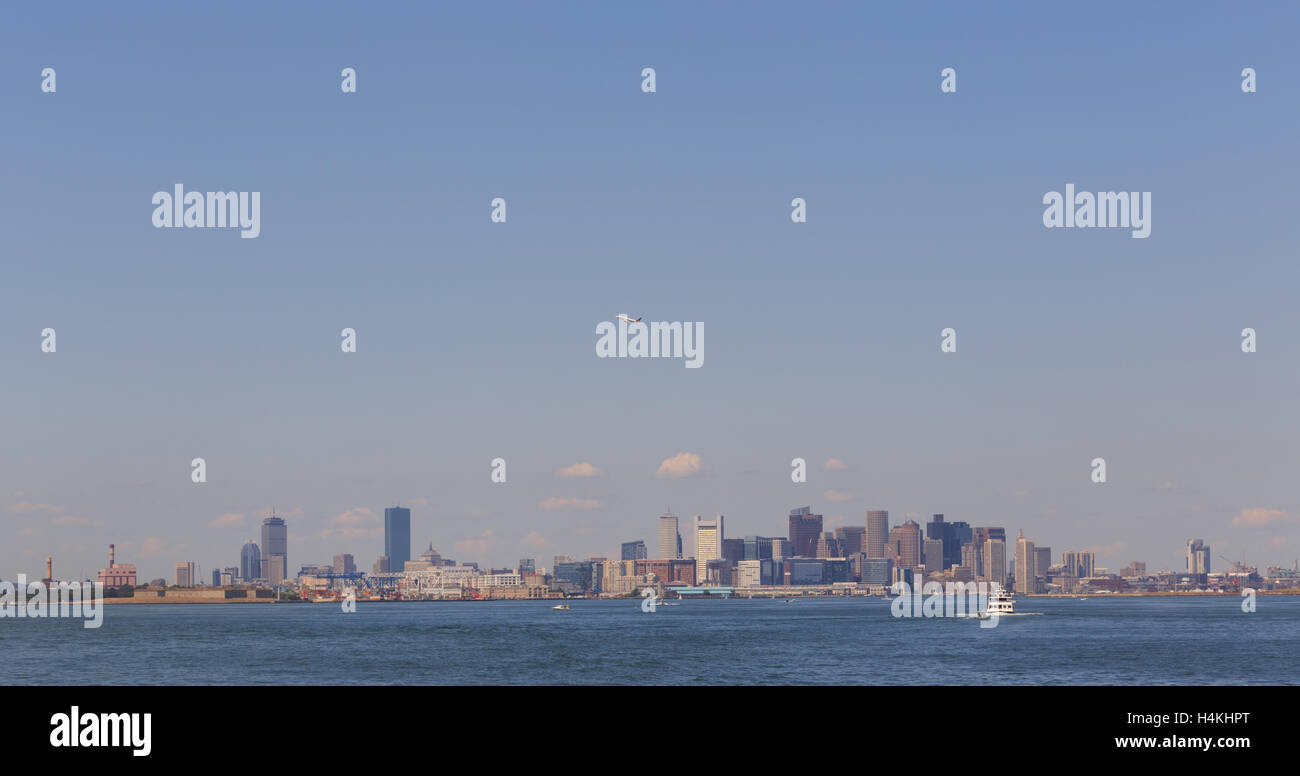 A photograph of a plane flying over the Boston Skyline, as seen from a ...