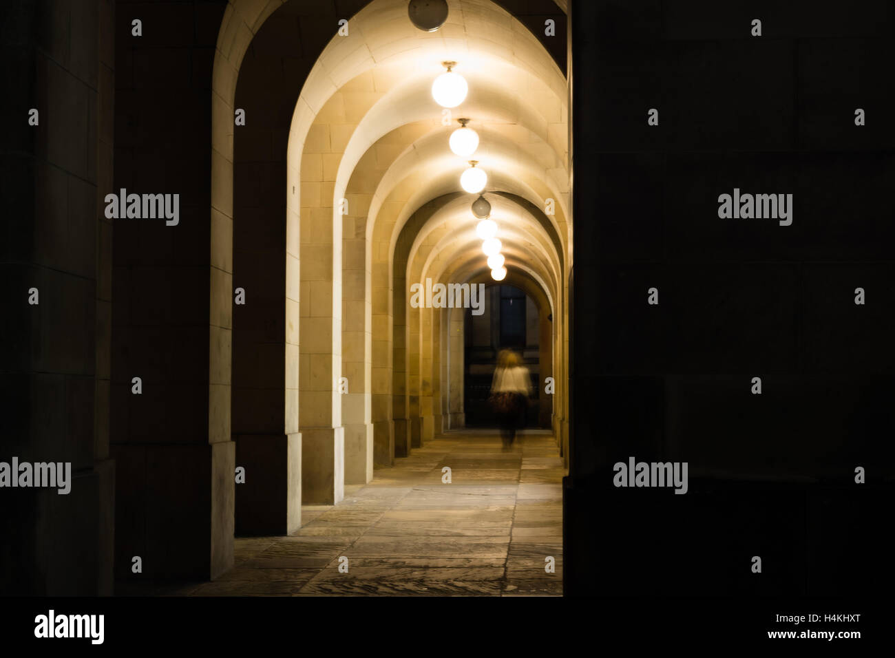 walkway in Manchester given long exposure. Female walked down corridor ...