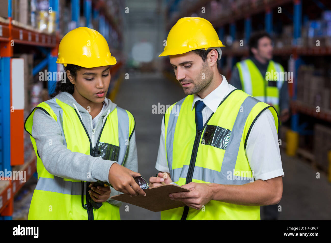 Warehouse workers interacting with each other Stock Photo - Alamy