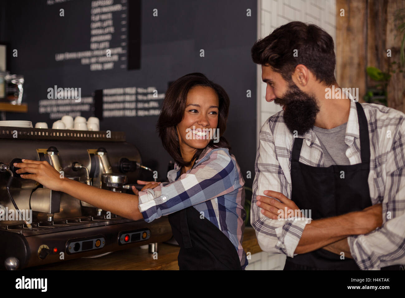 Waiter and waitress interacting while working in kitchen Stock Photo ...