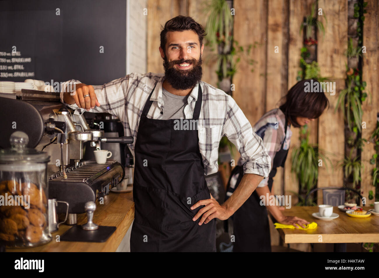 Smiling waiter standing in kitchen at caf├⌐ Stock Photo - Alamy