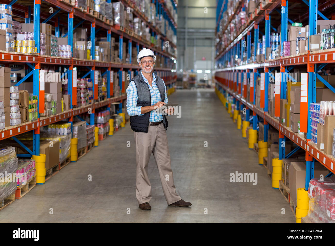 Portrait of warehouse worker using digital tablet Stock Photo - Alamy