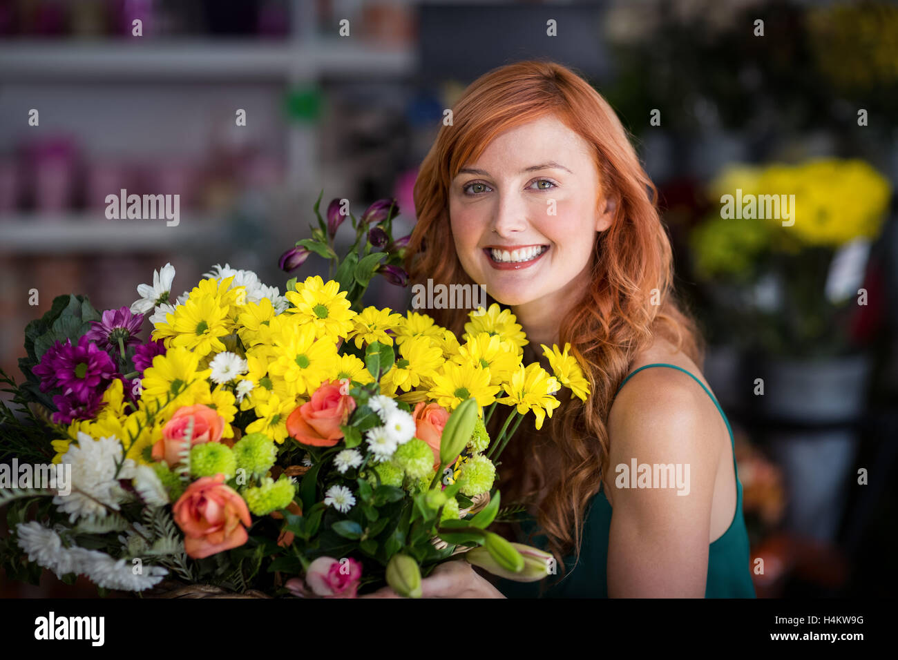 Happy female florist holding bunch of flowers Stock Photo - Alamy