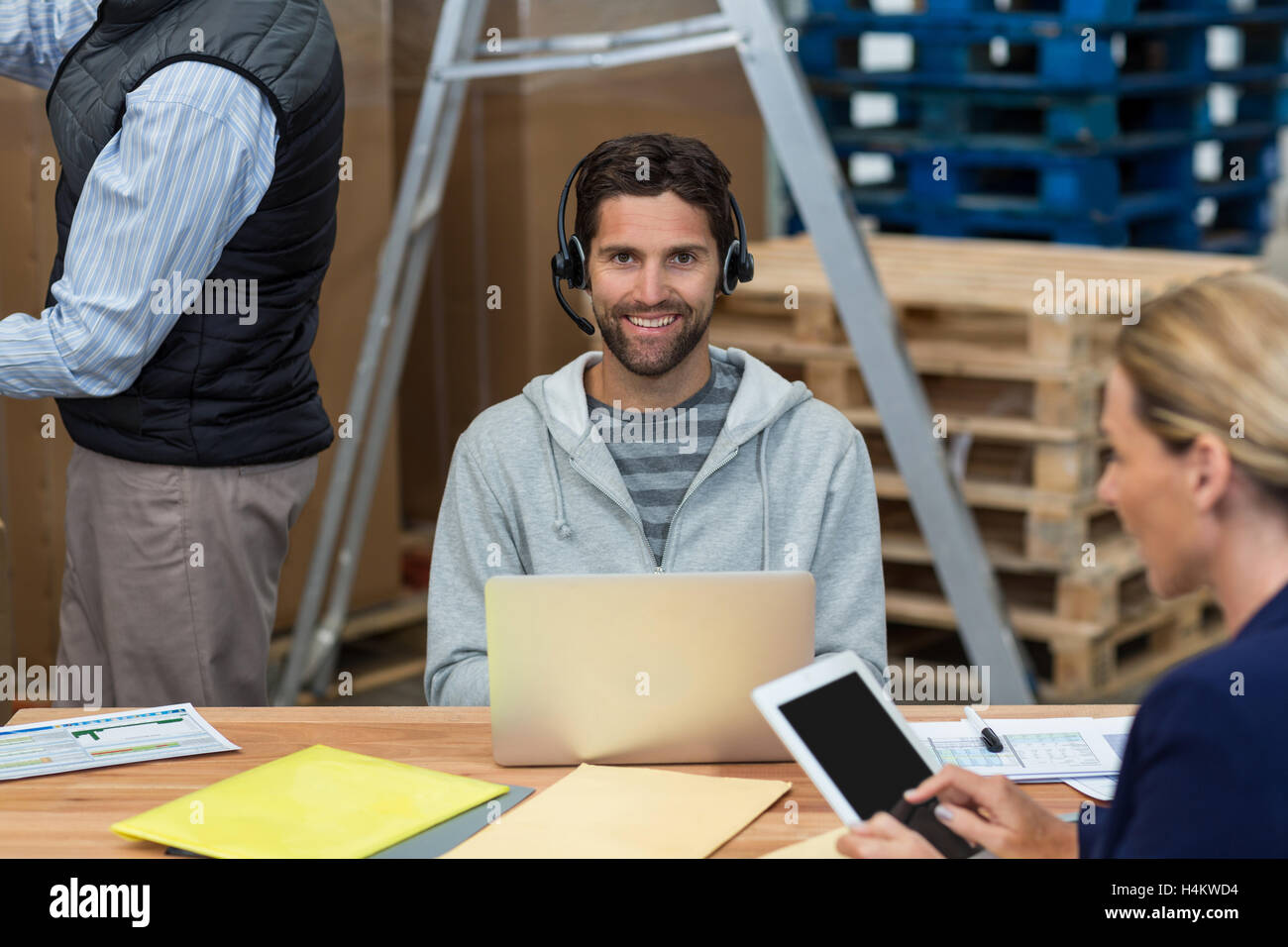 Man using laptop in warehouse Stock Photo - Alamy