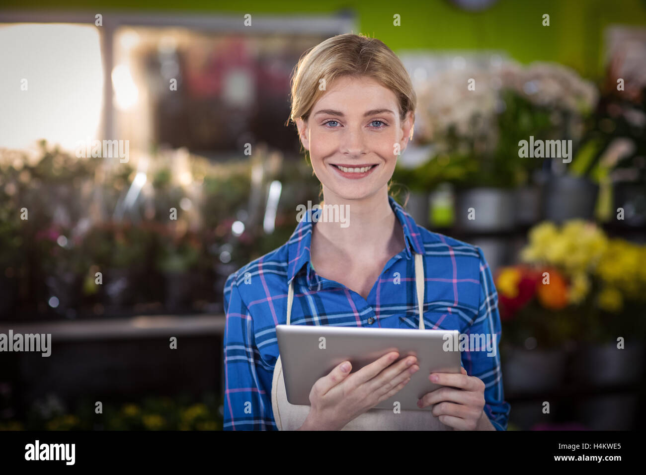 Female florist holding digital tablet Stock Photo - Alamy