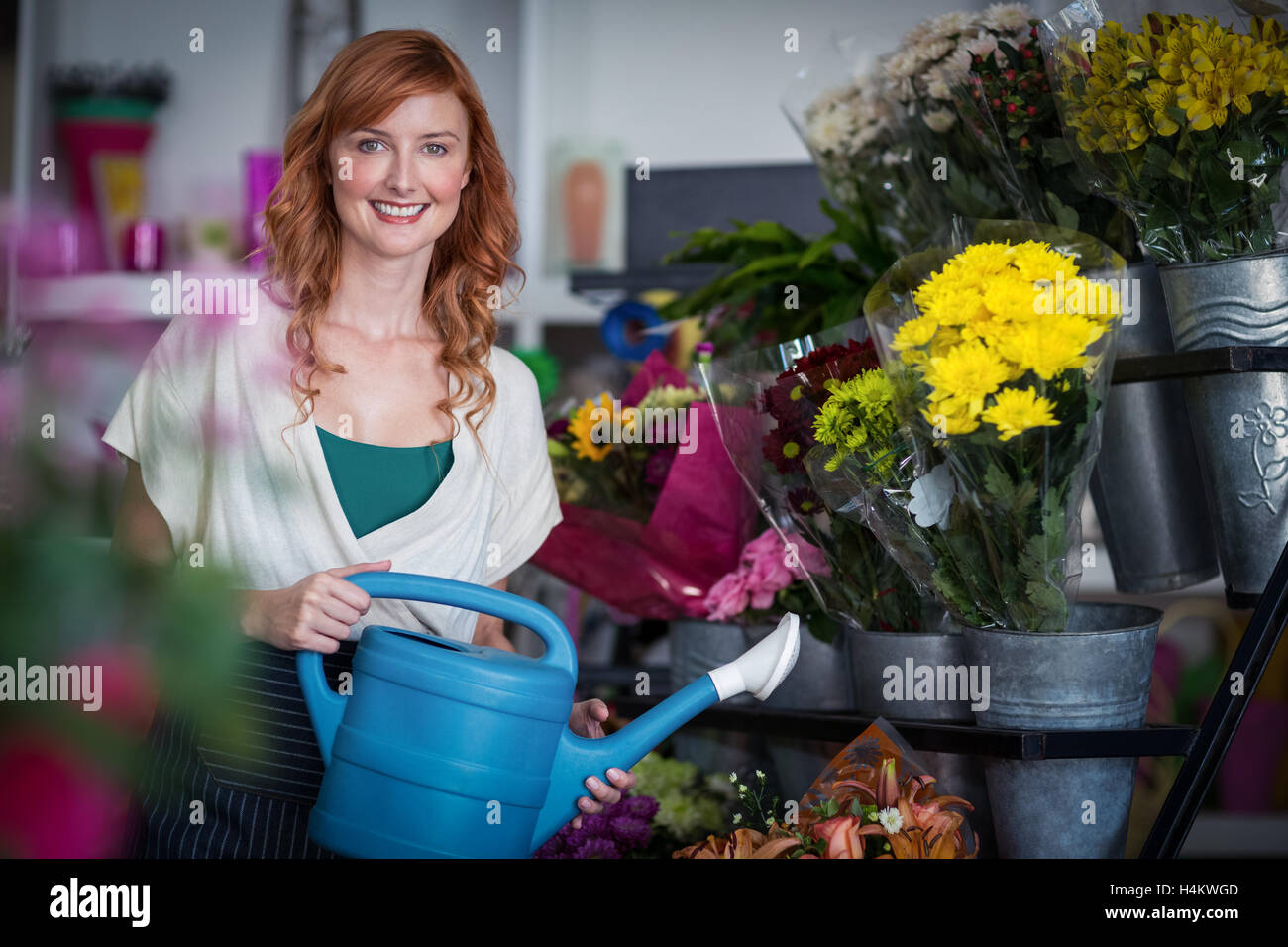 Cheerful female florist pouring hi-res stock photography and images - Alamy