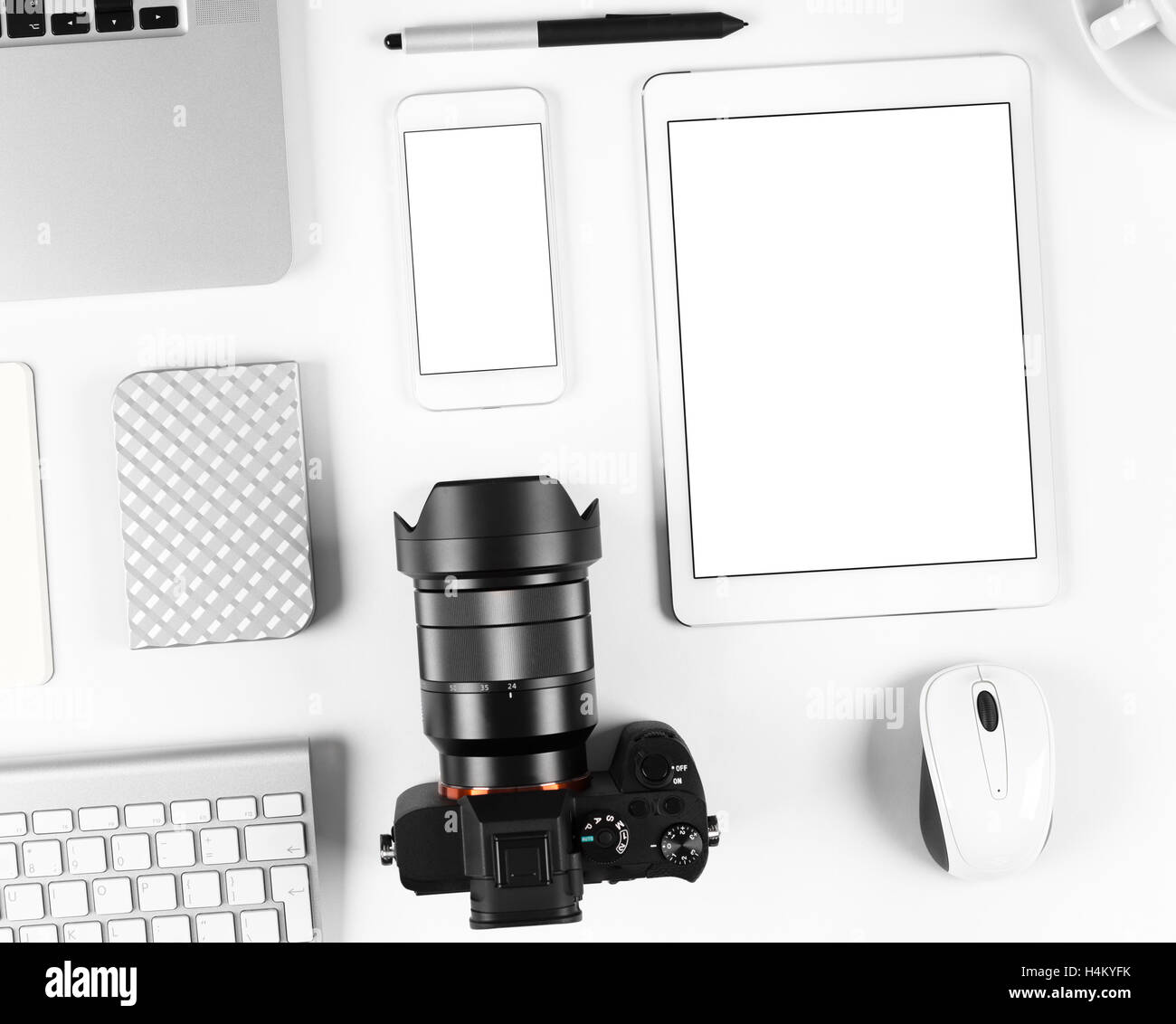 Top view of photographer workplace: Keyboard, tablet, camera and ...