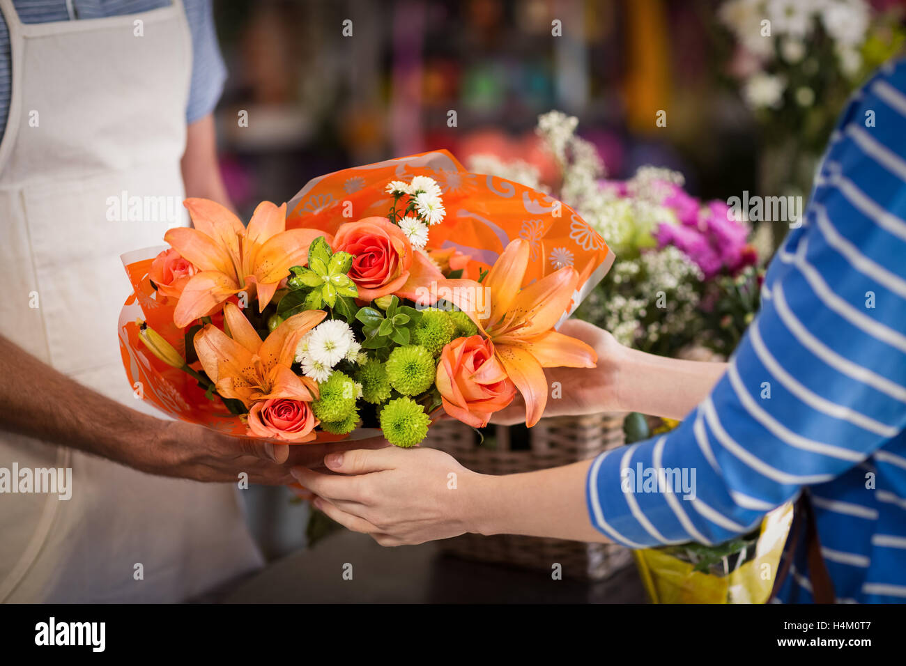 Florist giving bouquet of flower to customer Stock Photo - Alamy