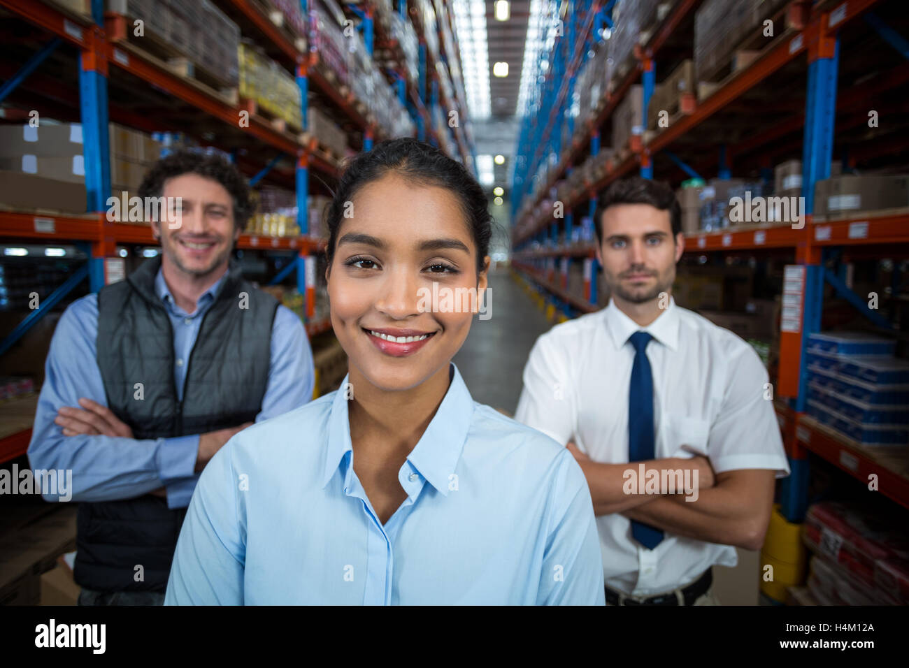 Portrait of warehouse team standing with arms crossed Stock Photo - Alamy
