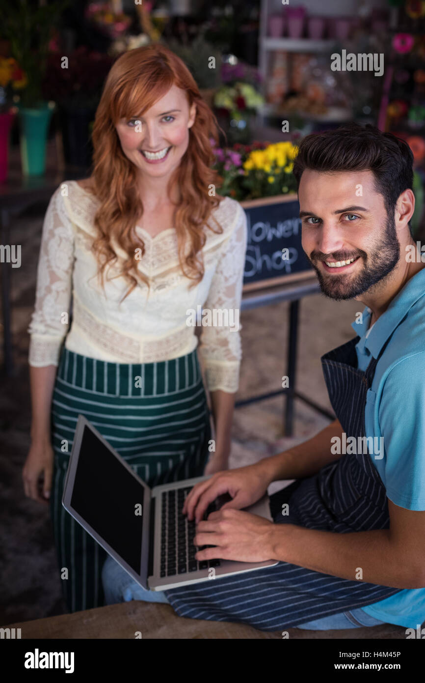 Happy couple using laptop Stock Photo - Alamy