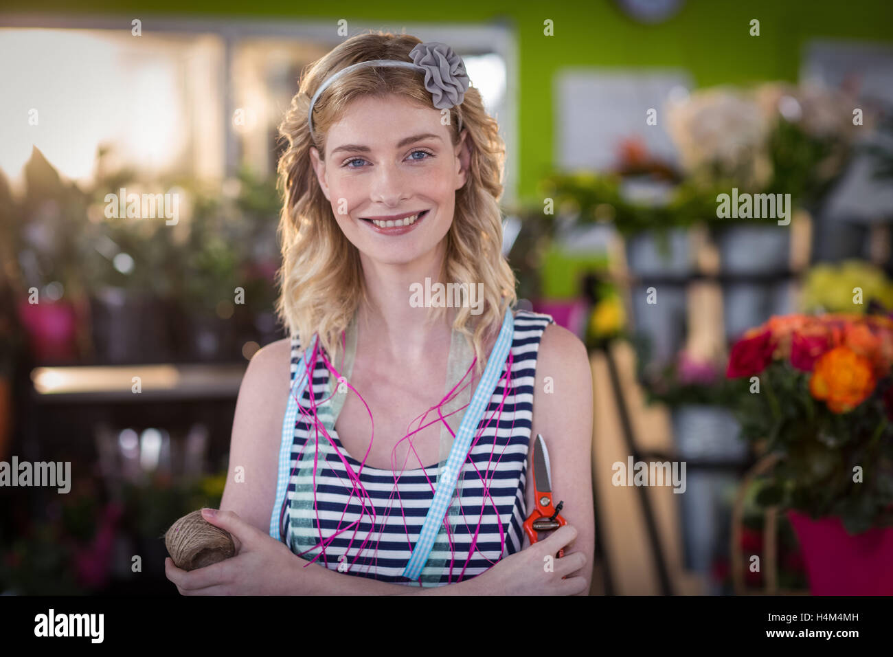 Portrait of female florist smiling Stock Photo - Alamy