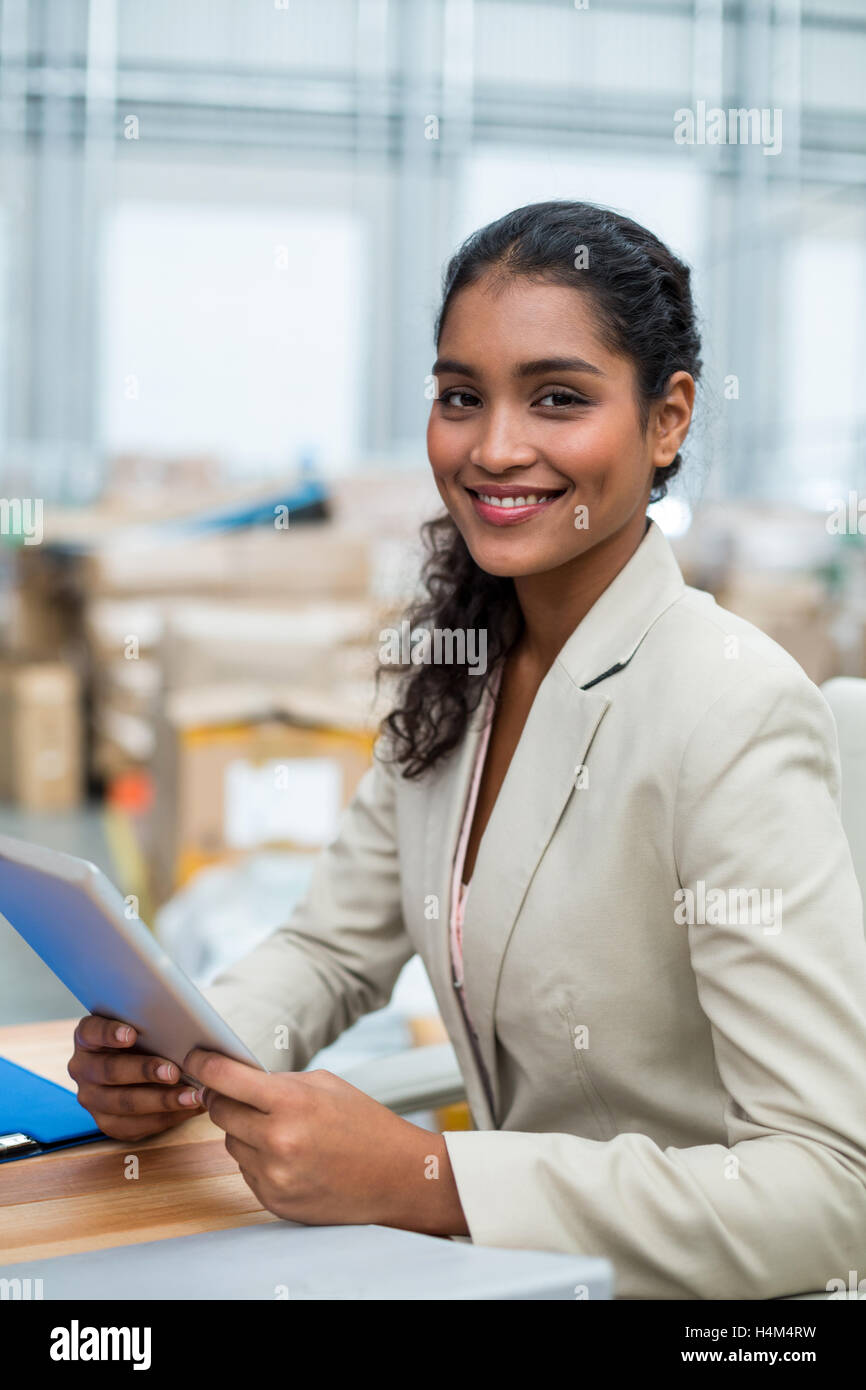 Portrait of smiling manager using digital tablet Stock Photo - Alamy