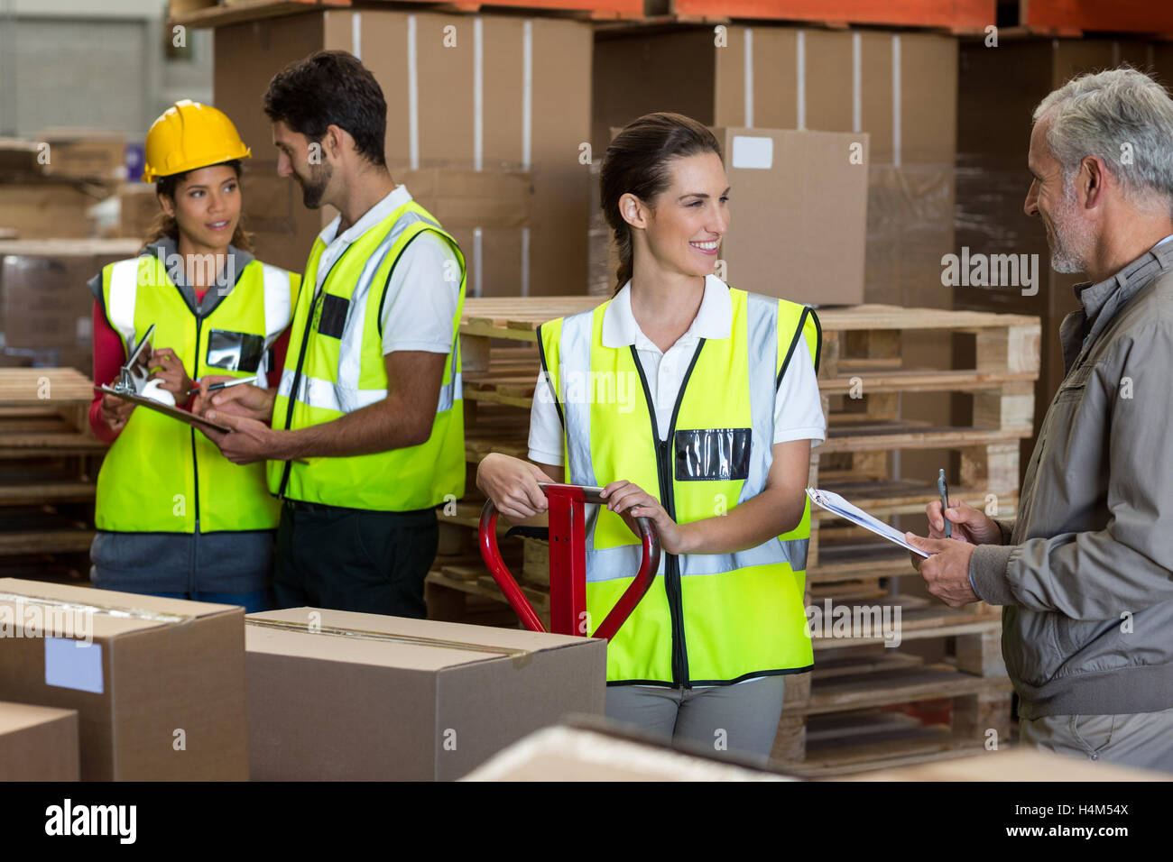 Warehouse manager and workers preparing a shipment Stock Photo - Alamy