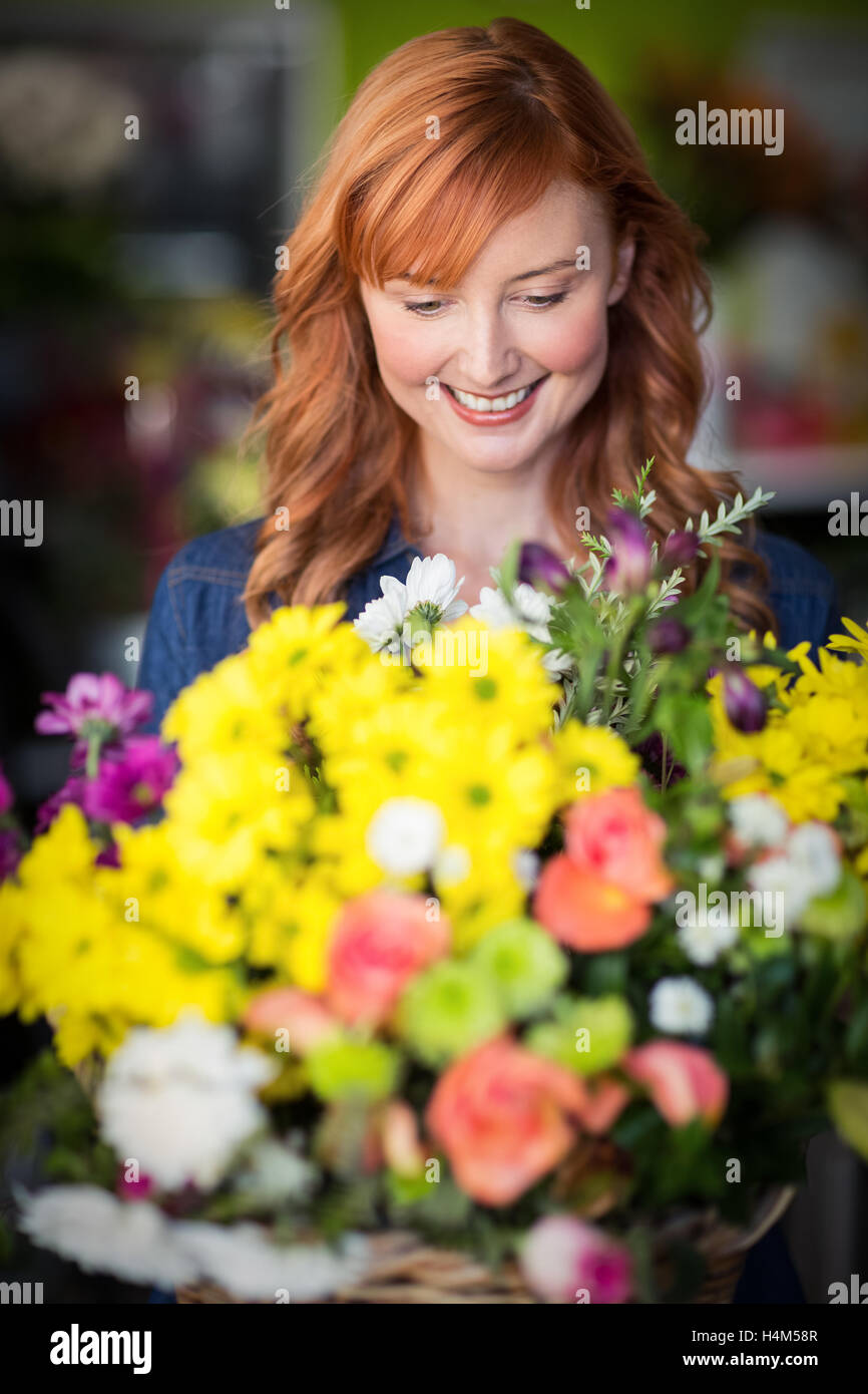 Female florist standing and smiling Stock Photo - Alamy