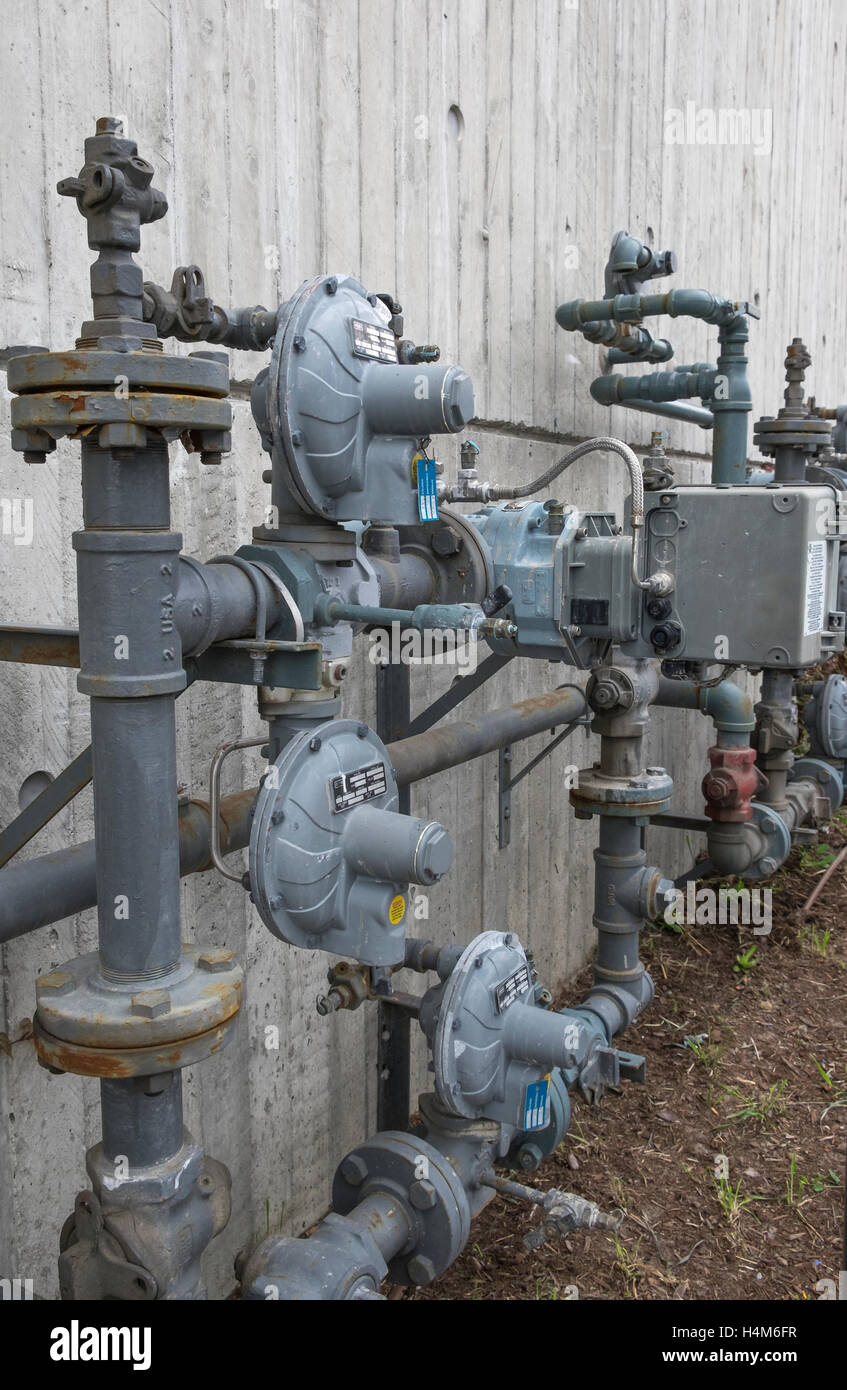 A vertical image of natural gas piping outside an apartment building ...