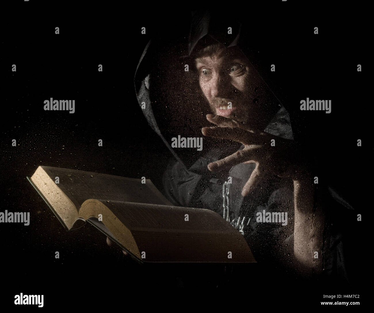 necromancer casts spells from thick ancient book, behind transparent ...