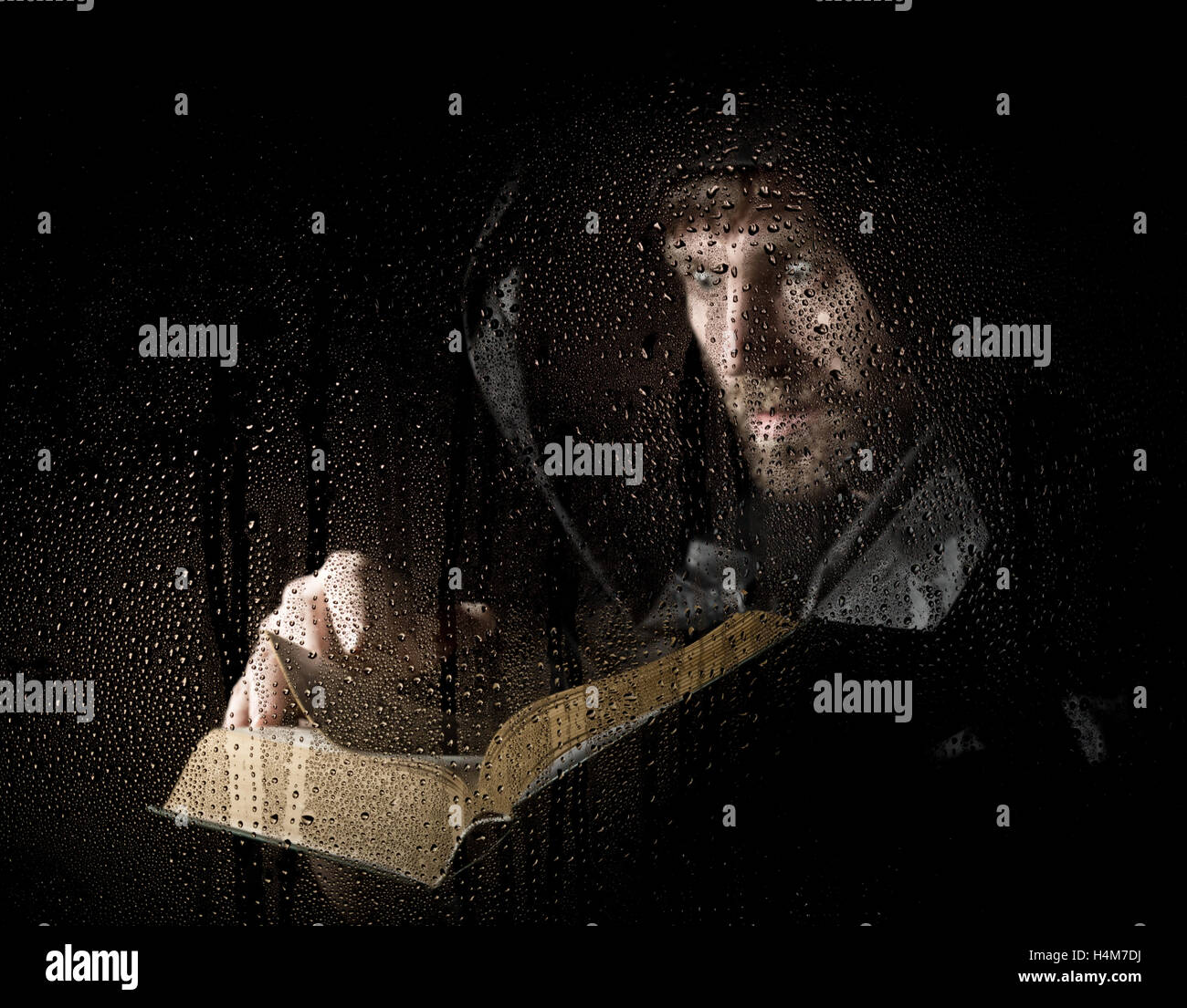 necromancer casts spells from thick ancient book, behind transparent ...