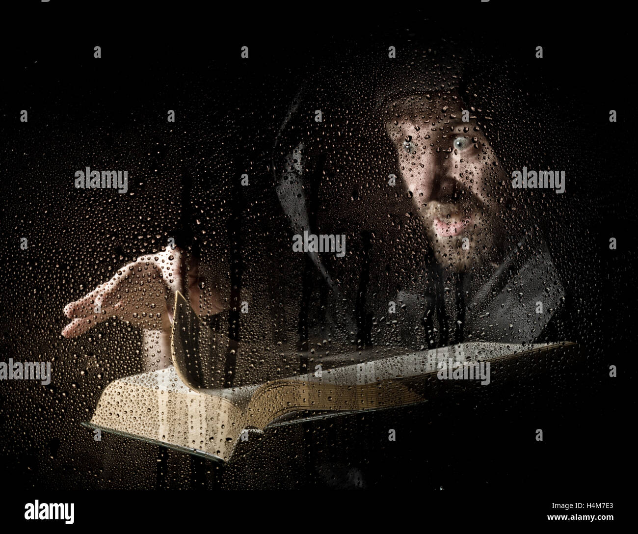 necromancer casts spells from thick ancient book, behind transparent ...