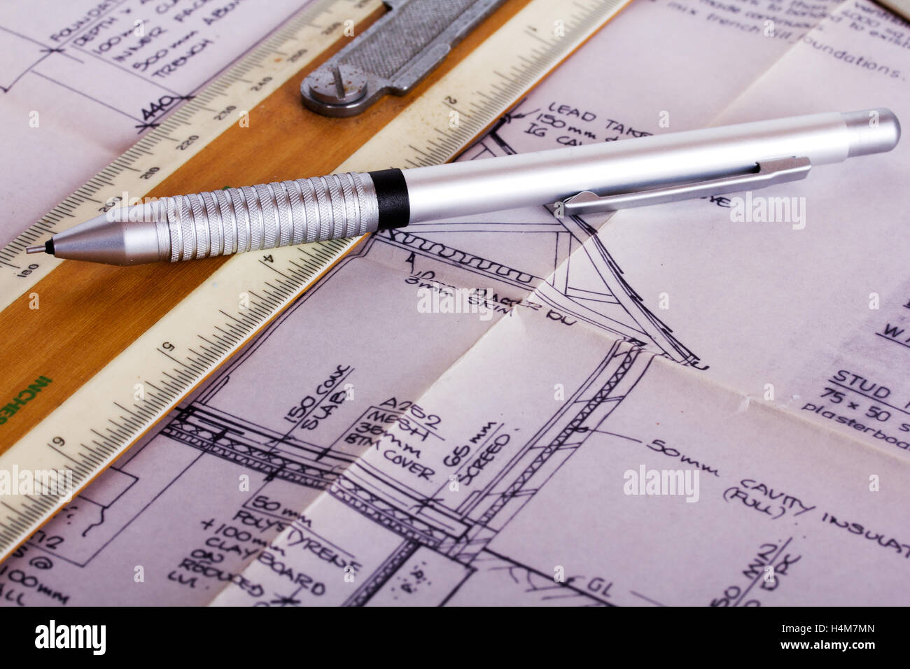 Drawing equipment on detailed architects house plans Stock Photo - Alamy