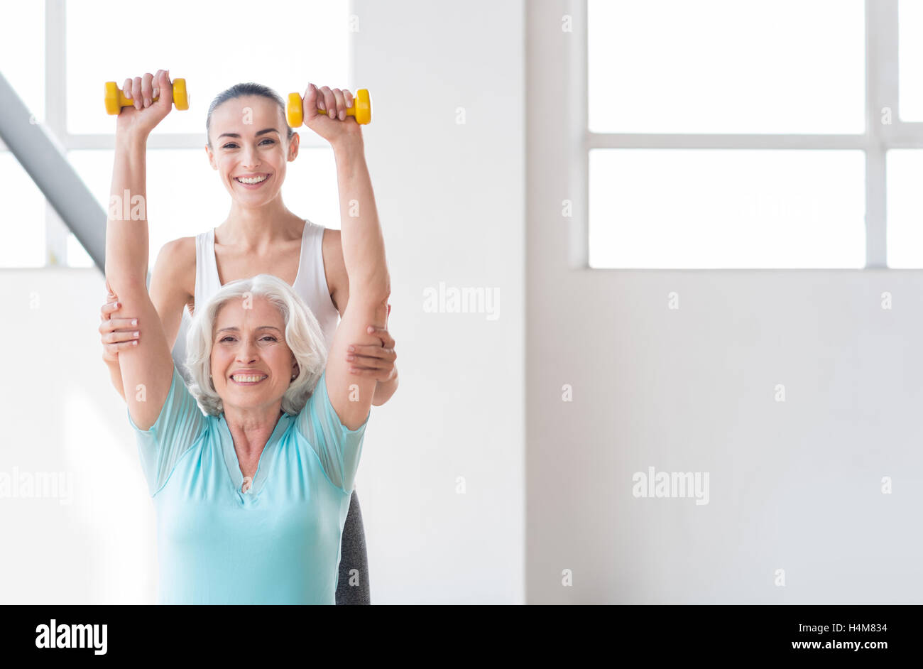 Happy young coach working out with the client Stock Photo - Alamy