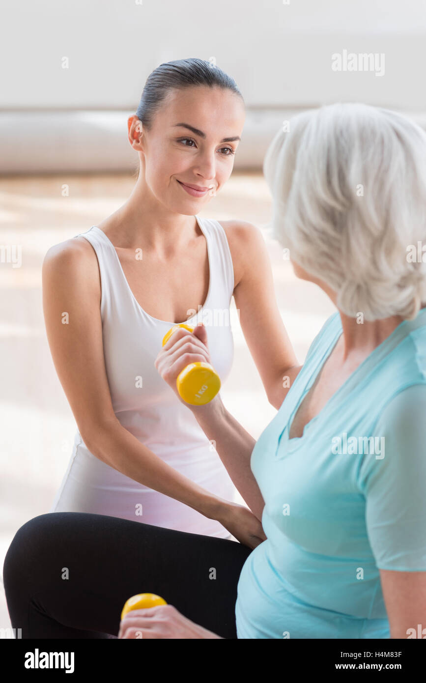 Masterful positive coach sitting near the client Stock Photo - Alamy