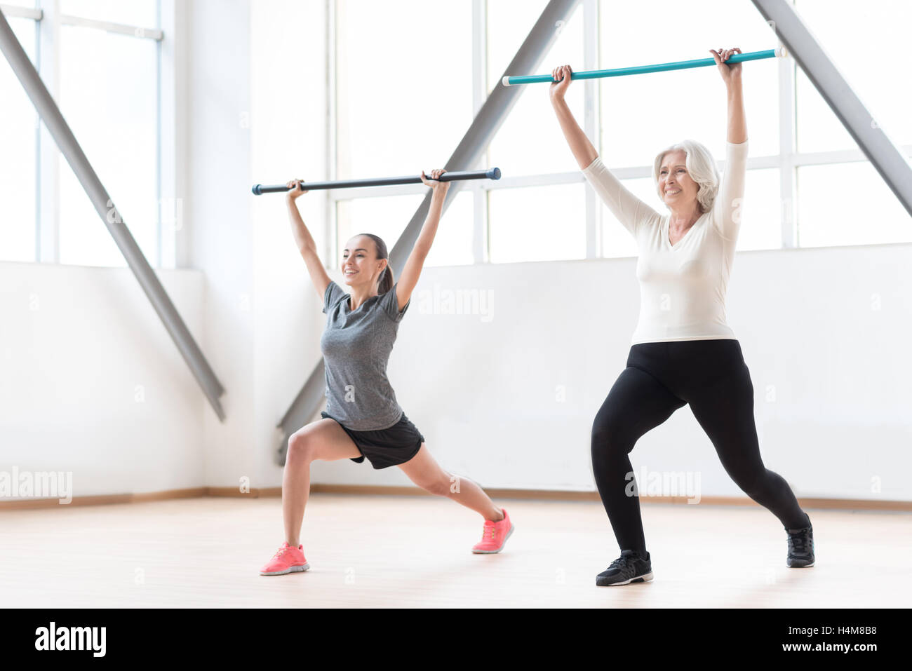 Positive nice women holding plastic sticks Stock Photo - Alamy