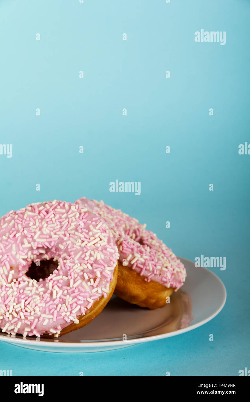 Iced doughnut on a light coloured blue background Stock Photo - Alamy