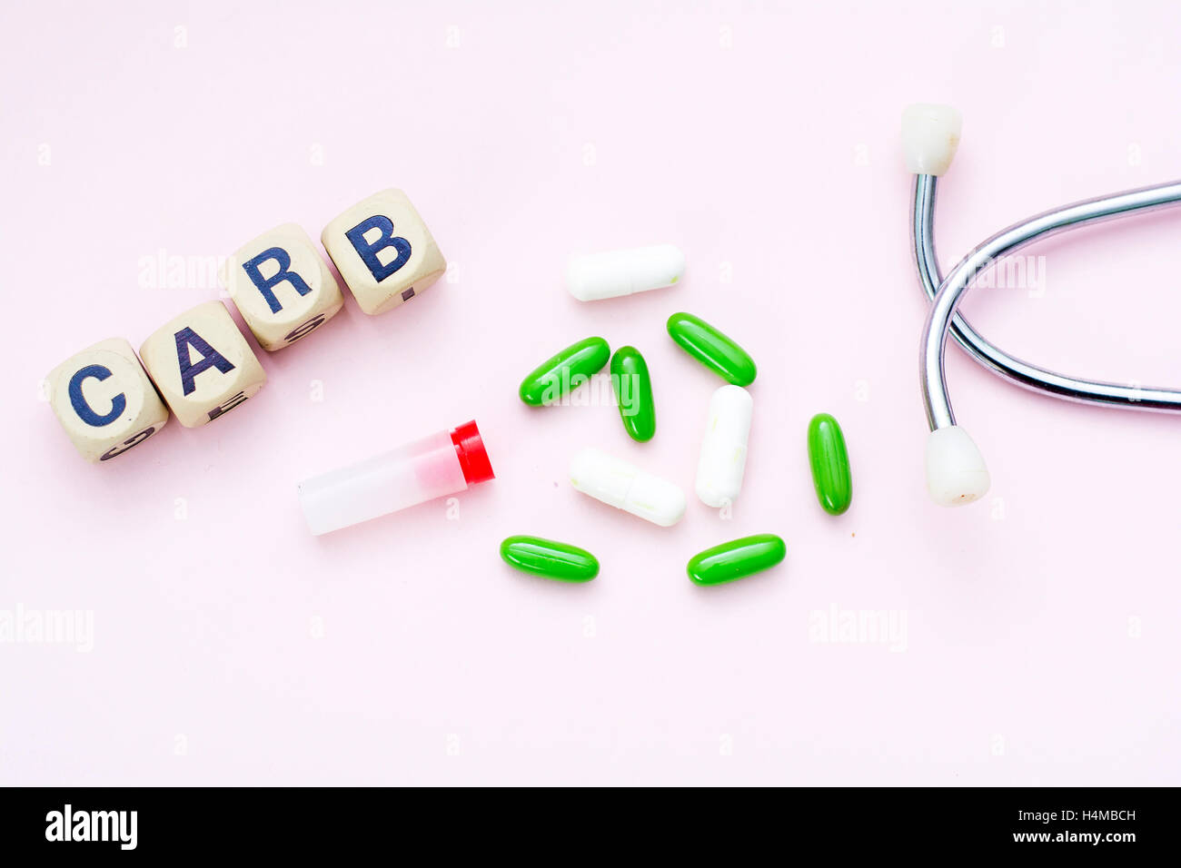 Pink background inscription carb, pills and stethoscope Stock Photo - Alamy