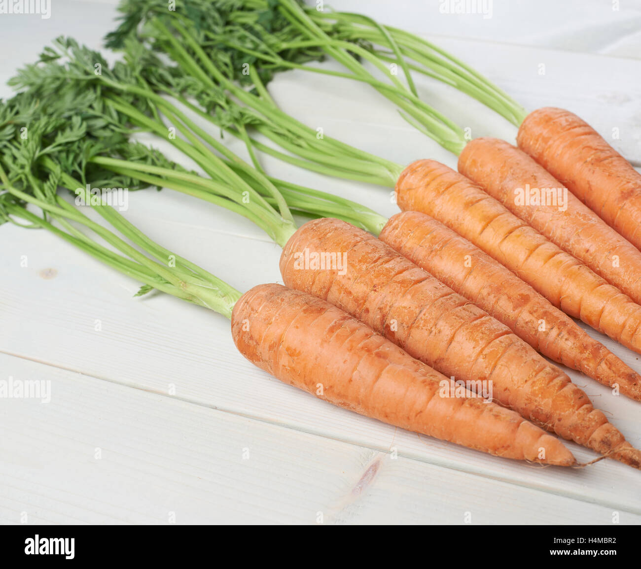 Raw whole carrot on wooden surface table Stock Photo - Alamy