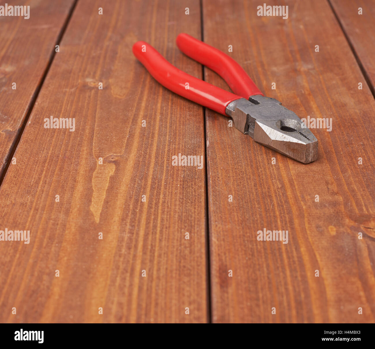 Lineman's combination pliers hand tool on wooden surface Stock Photo ...