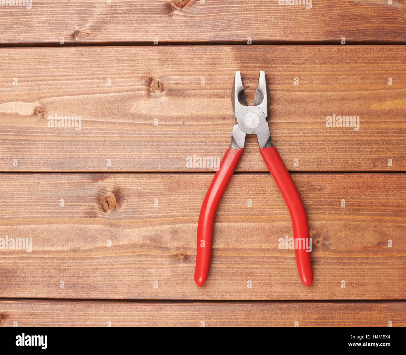 Lineman's combination pliers hand tool on wooden surface Stock Photo ...