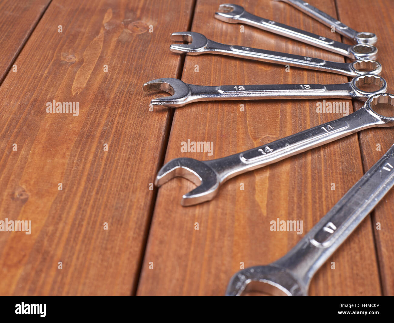 Set of wrenchs chrome metal spanner instruments on wooden surface Stock ...
