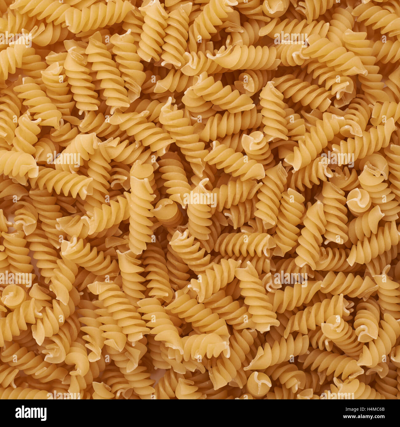 Pile of rotini yellow pasta as abstract background Stock Photo - Alamy