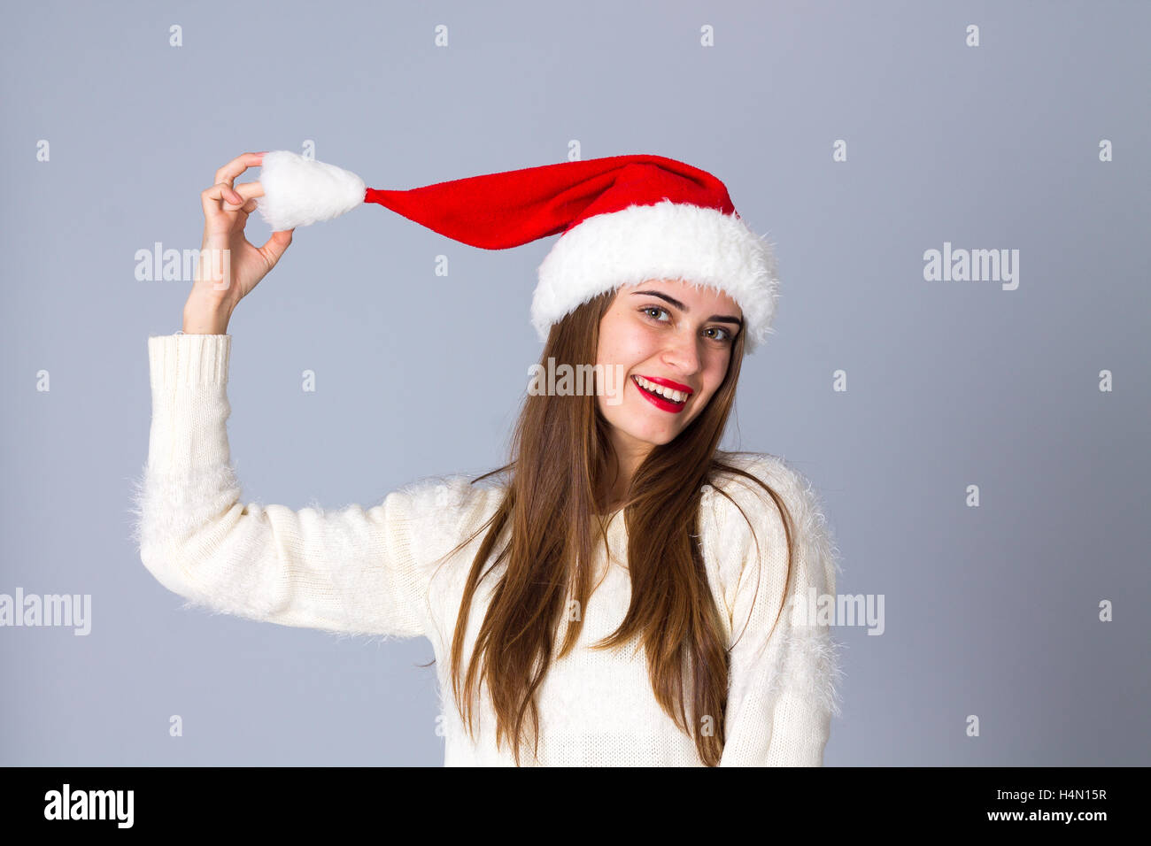 Woman in red christmas hat Stock Photo - Alamy