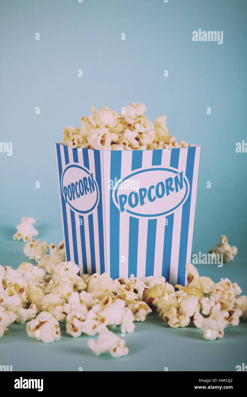Bucket of popcorn against a blue background Vintage Retro Filter Stock ...