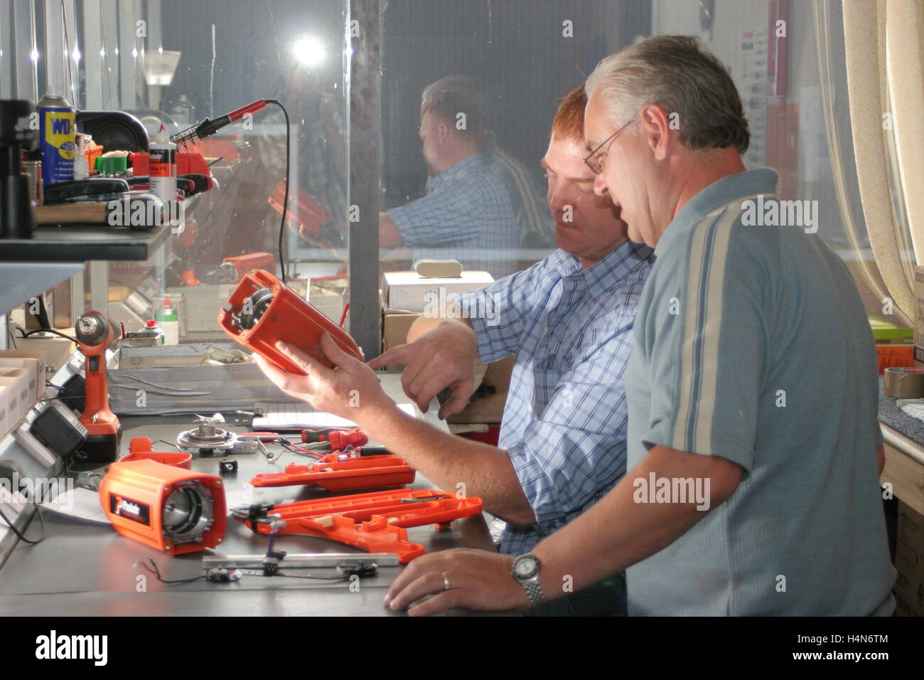 Two engineers discuss maintenance work hi-res stock photography and ...