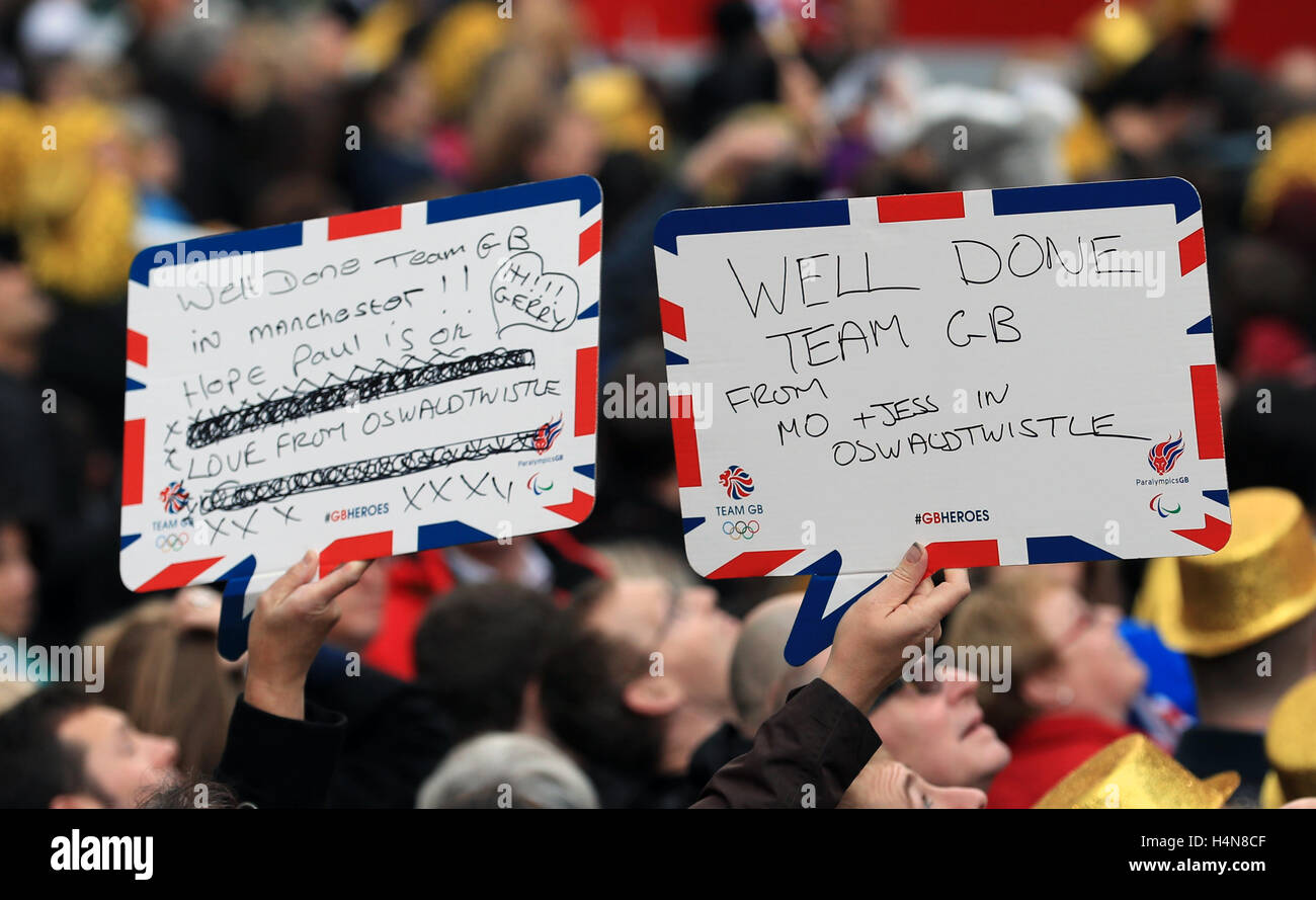 Members of the crowd hold up signs during the Olympic and Paralympic ...