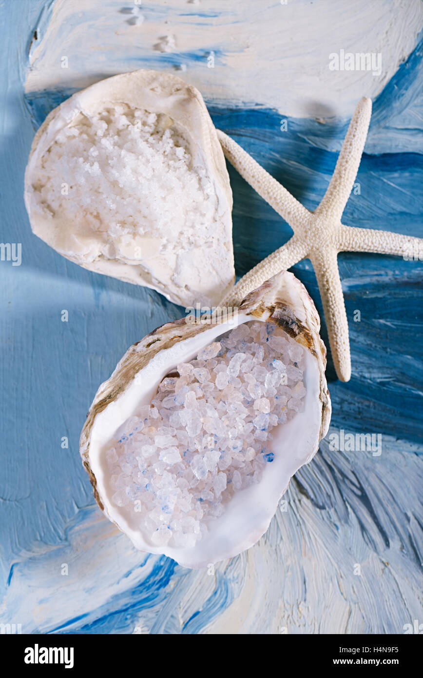 Blue persian sea salt in sea shell oyster and star fish on blue ...